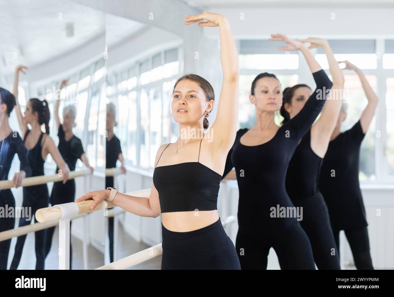 Girl practicing battement tendu at barre during ballet class Stock ...