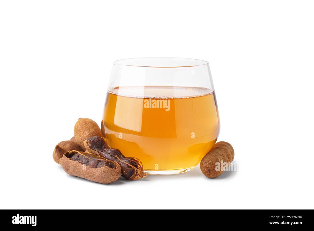 Glass of tasty tamarind drink and fruits on white background Stock ...