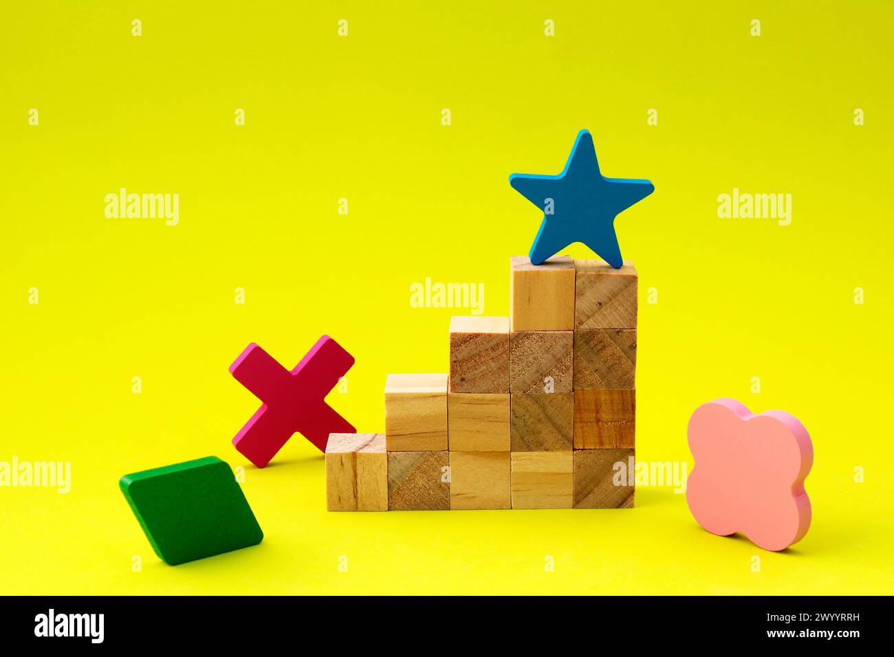 Star at the top of ladder made with wooden cubes and other figures ...