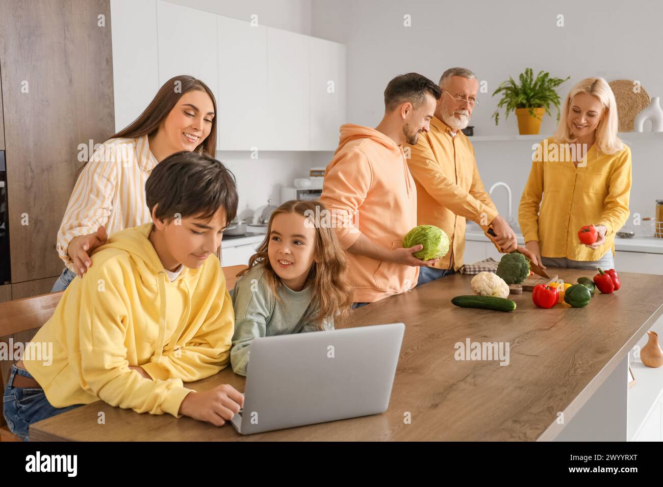 Big family cooking in kitchen Stock Photo - Alamy