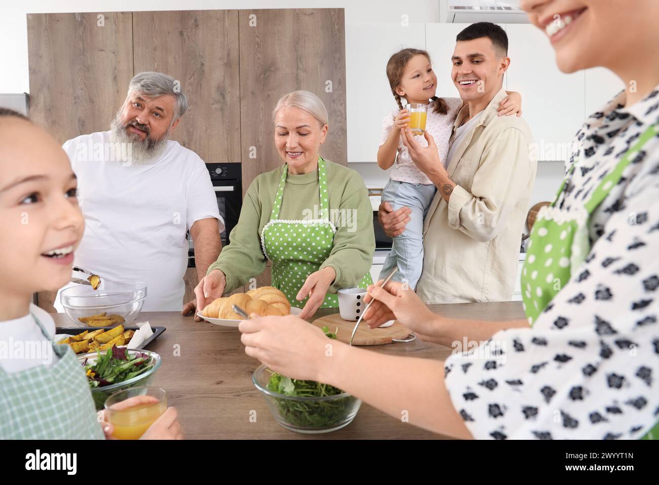 Big family cooking in kitchen Stock Photo - Alamy