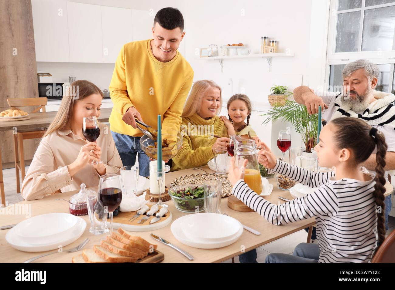 Big family having dinner in kitchen Stock Photo - Alamy