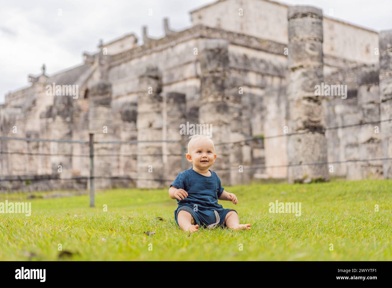 Baby traveler, tourists observing the old pyramid and temple of the ...