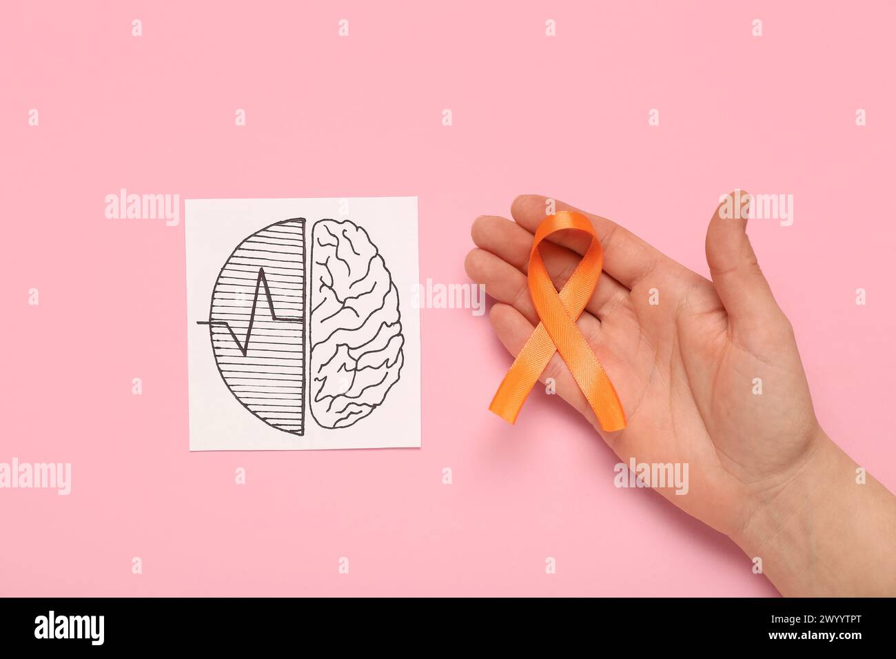 Drawing of brains and female hand with orange ribbon on pink background ...