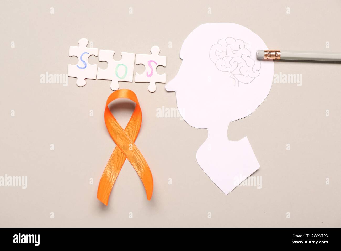 Orange ribbon, paper human head and word SOS on grey background ...