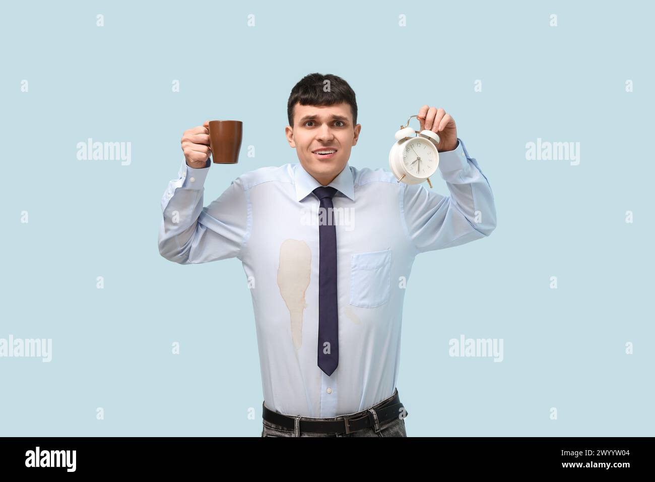 Confused man with coffee stains on his shirt on blue background Stock ...
