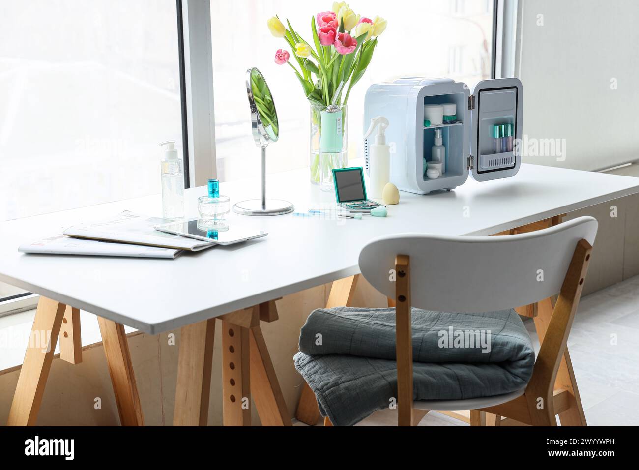 Small cosmetic refrigerator on table near window Stock Photo - Alamy