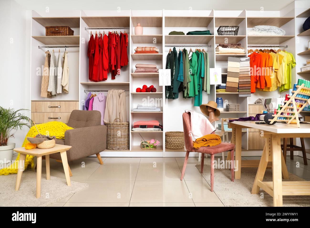 Interior of atelier with tailor's workplace, armchair and shelves Stock ...