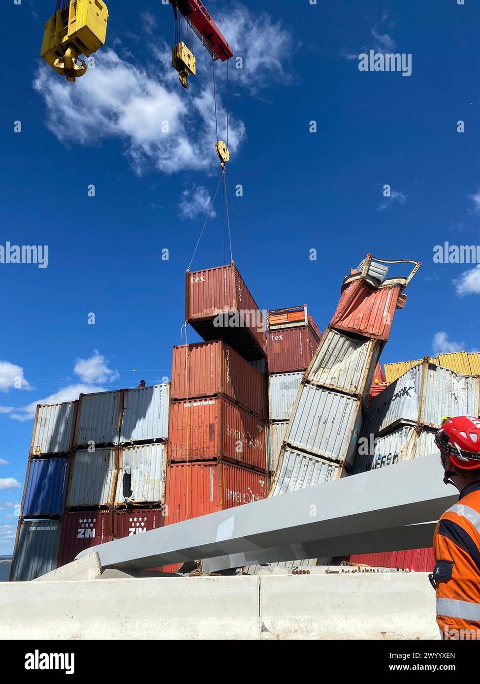 Response crews began removing shipping containers using a floating ...