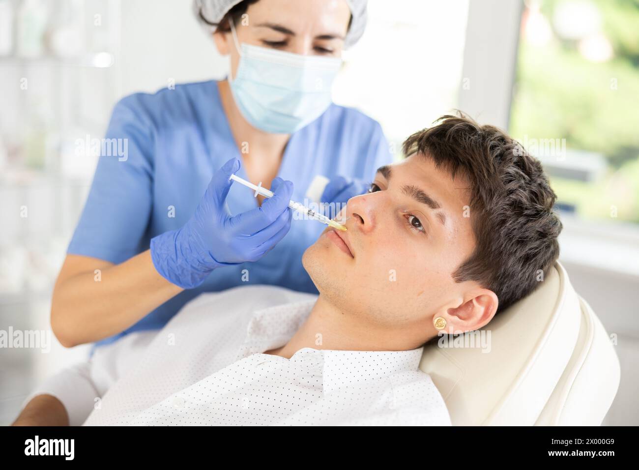 Facial injection male patient Stock Photo - Alamy