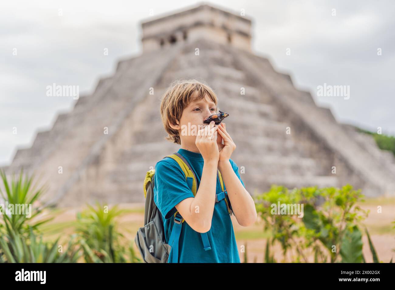 Boy traveler, tourists observing the old pyramid and temple of the ...