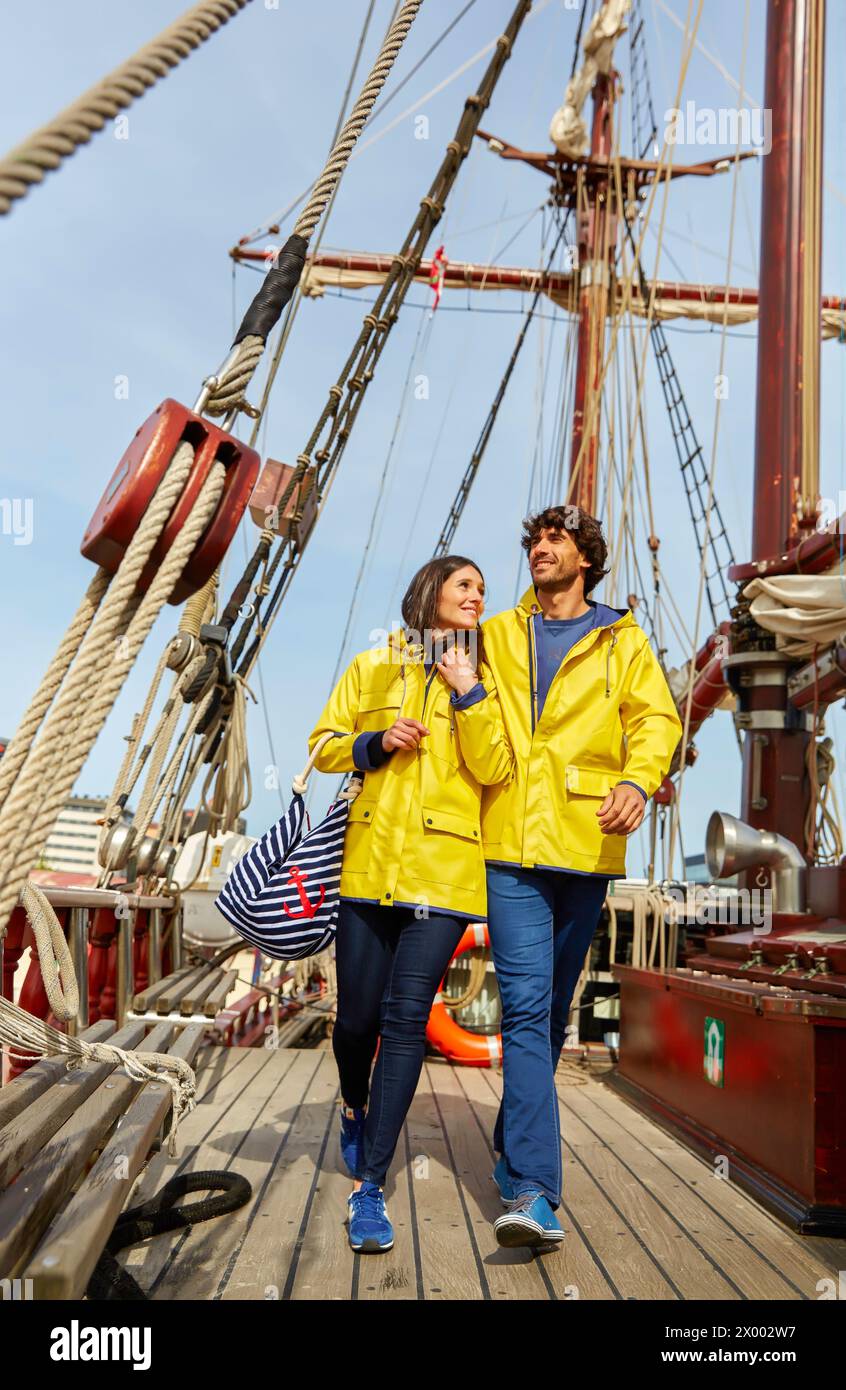 Couple outside a sailboat, galleon. Masts. Basque Country. Spain Stock ...