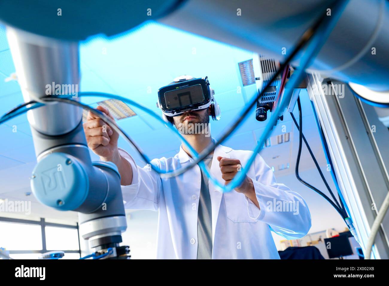 Robotic arm with artificial vision, Researcher with virtual reality glasses, VR, Humanoid robot ...