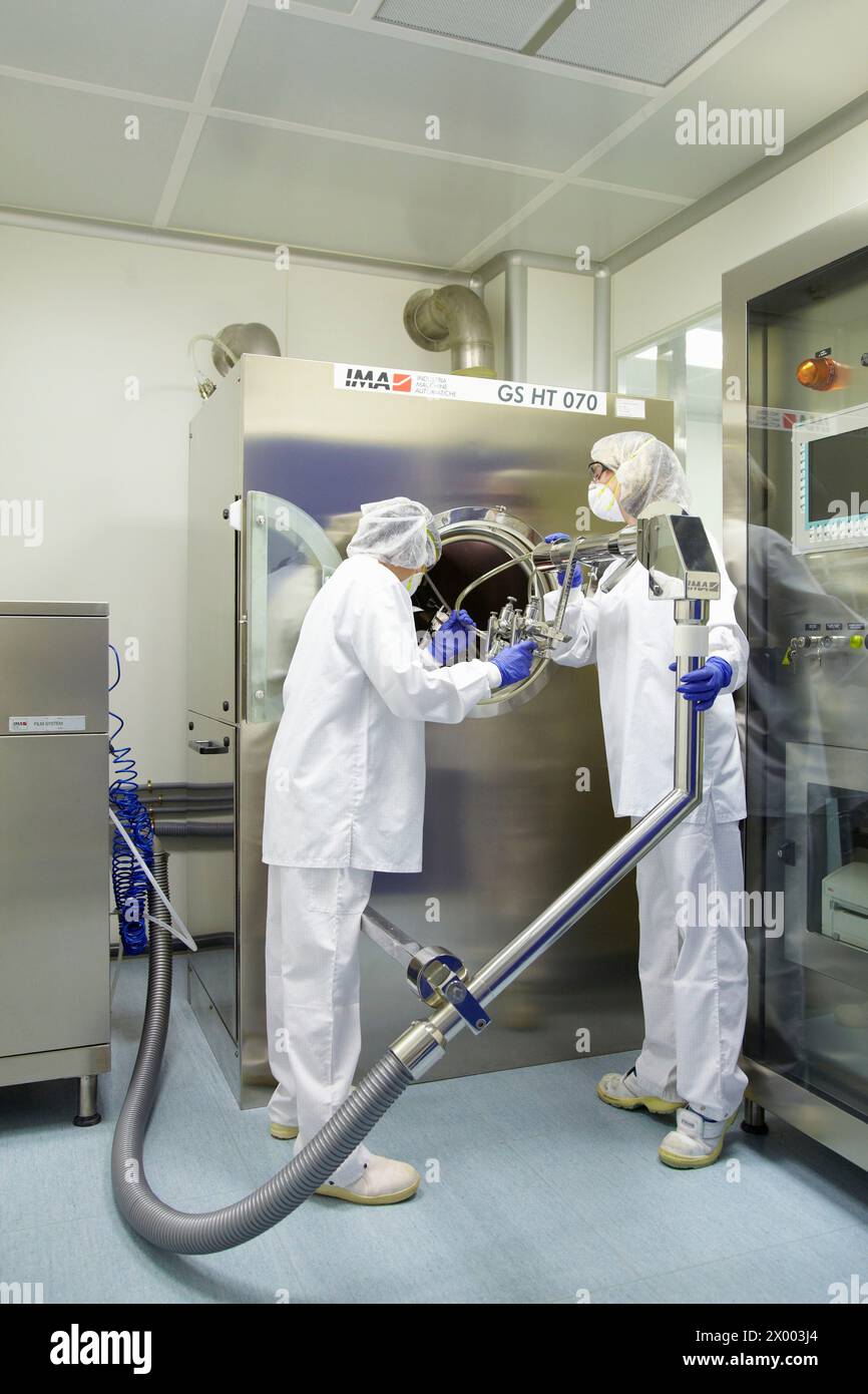 Technicians preparing a tablet coating process, Clean room ...