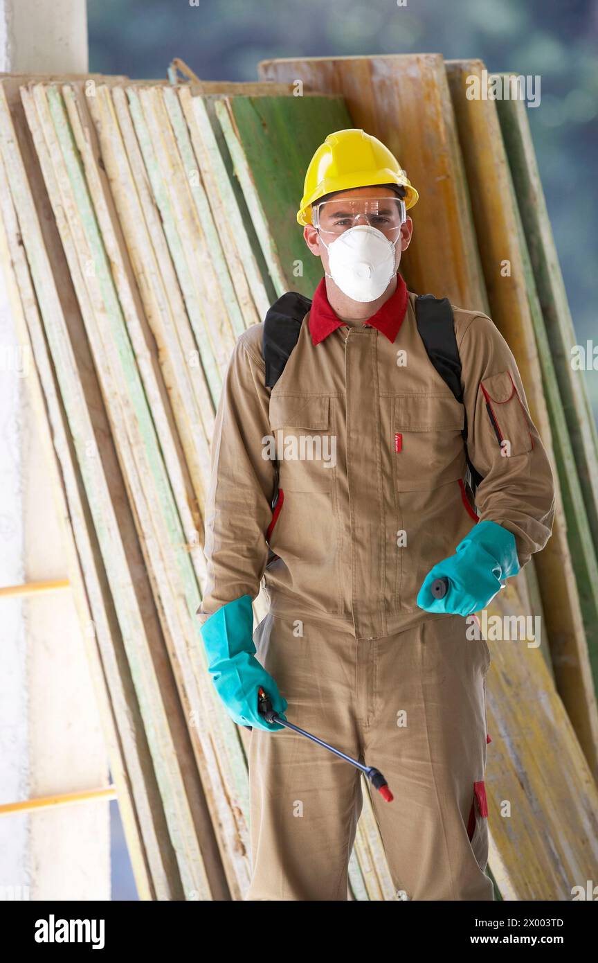 Applying form release agents with sprayer, concrete formworks, housing ...