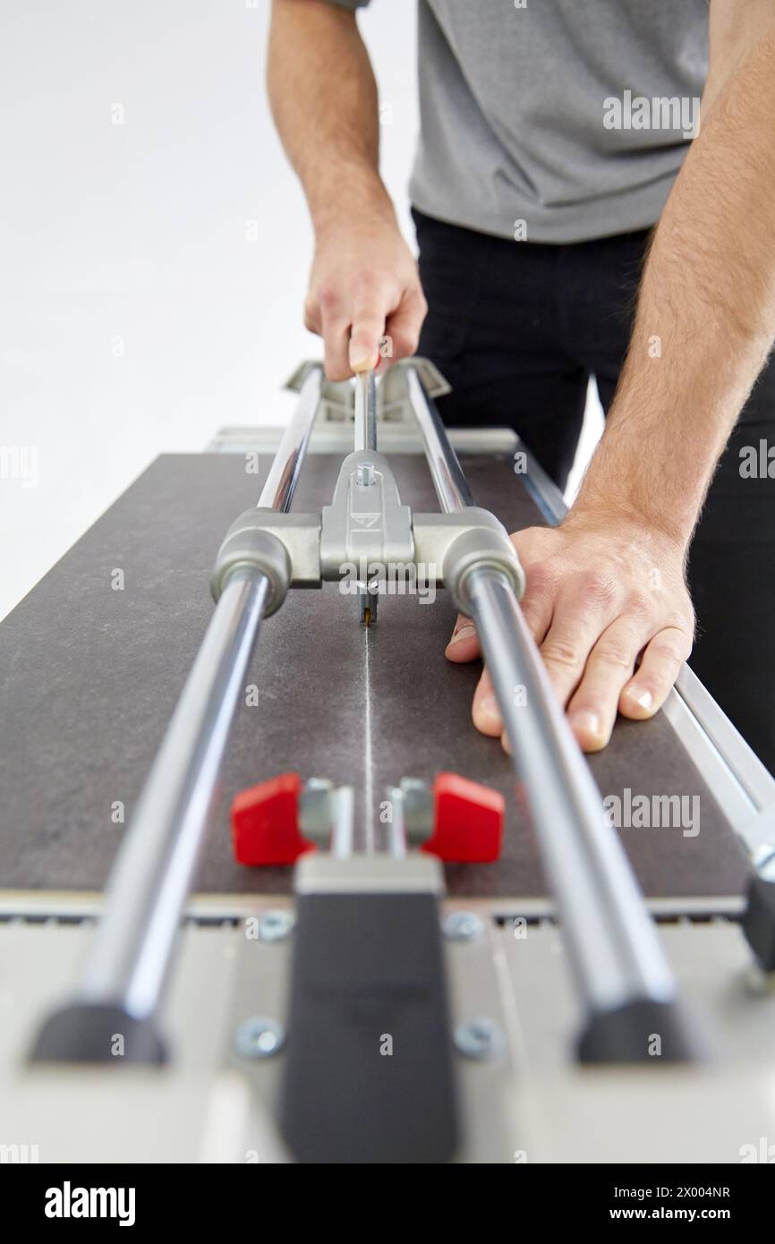 Bricklayer cutting tile. Manual tile cutter. Construction Industry ...