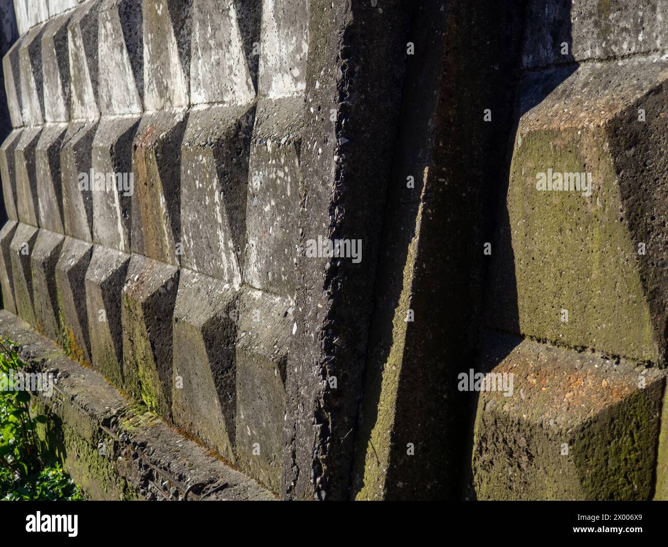 Old concrete fence. Greening concrete. Stone construction. Solid ...
