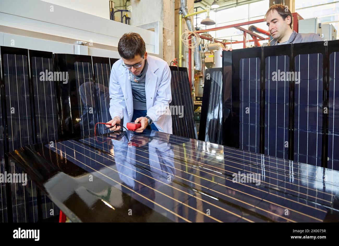 Two workers check solar panels hi-res stock photography and images - Alamy