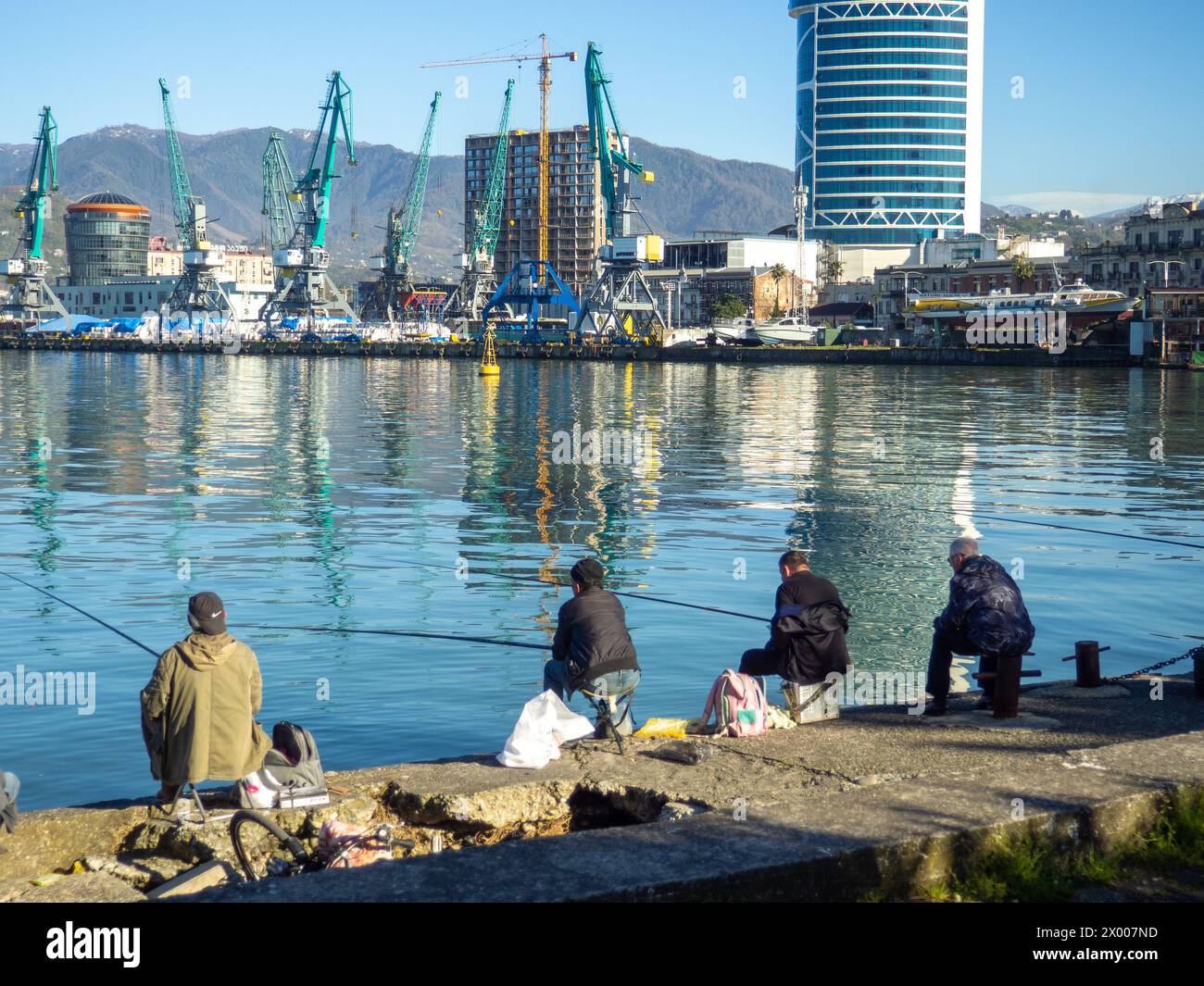 Batumi, Georgia. 03.27.2024 Fishermen with long fishing rods on the ... Batumi, Georgia. 03.27.2024 Fishermen with long fishing rods on the ...