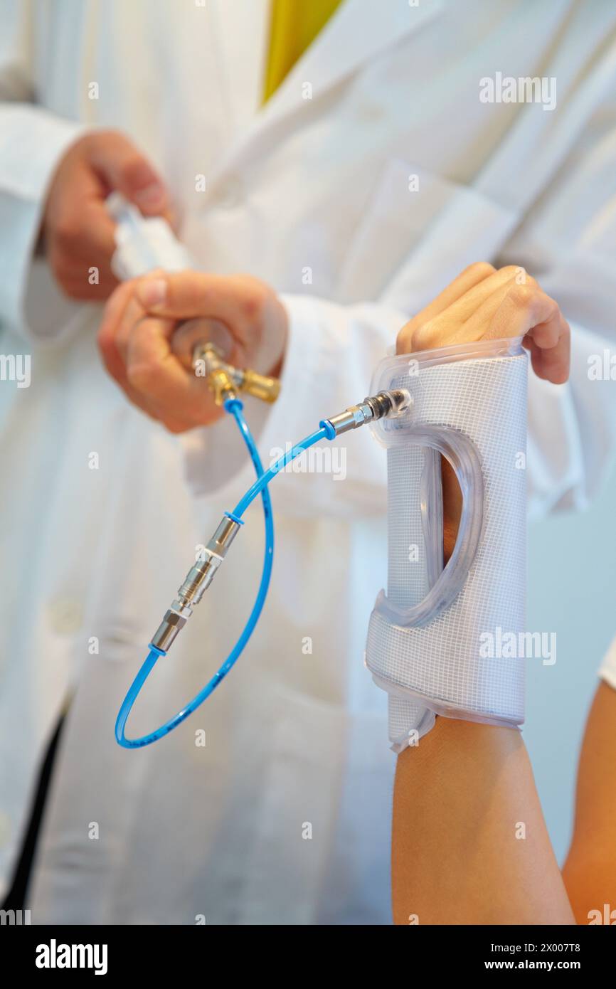 Researcher placing a patient splint prototype built with variable ...