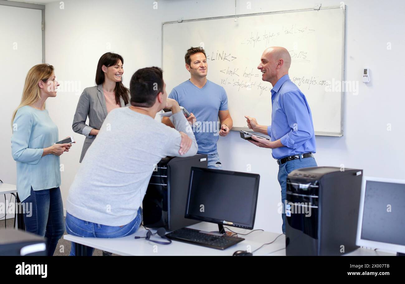 Three teachers talking hi-res stock photography and images - Alamy