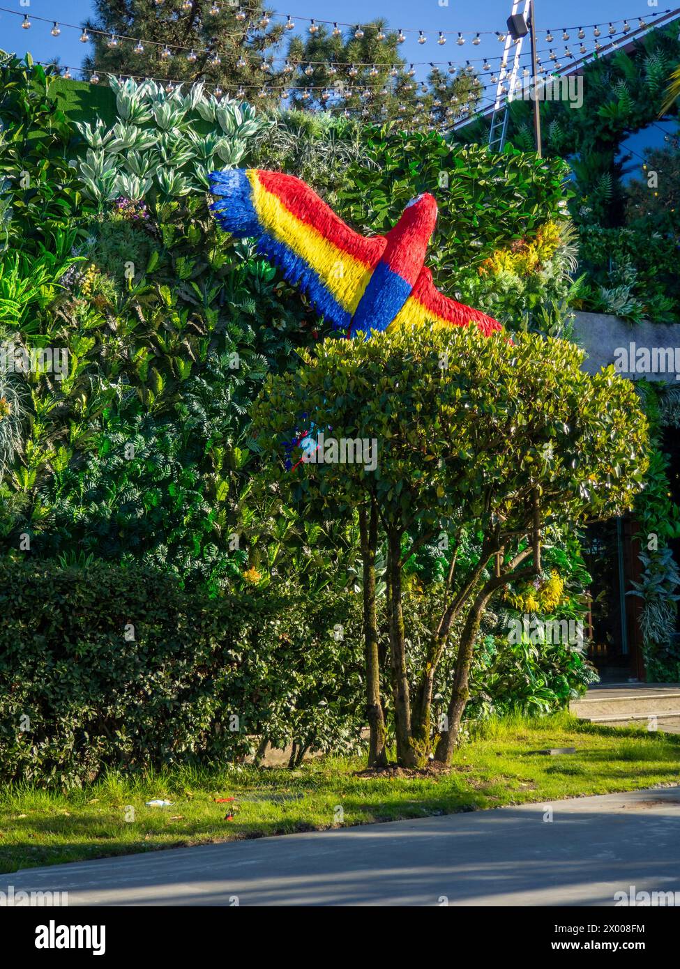 facade of the building is decorated with artificial birds. Parrots made ...