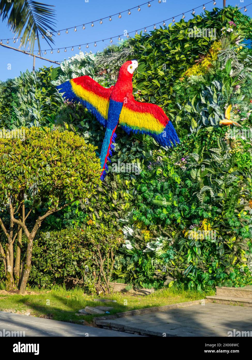facade of the building is decorated with artificial birds. Parrots made ...