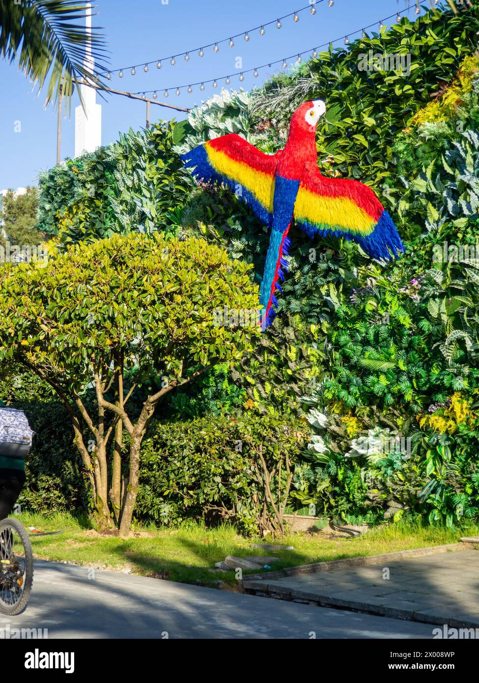 facade of the building is decorated with artificial birds. Parrots made ...