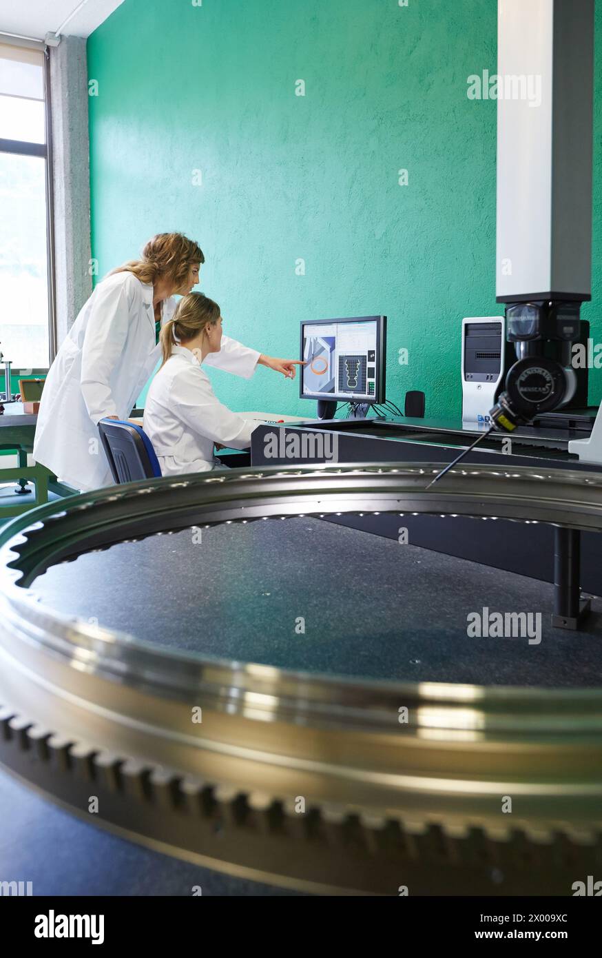 Technicians inspecting aircraft component. Measurement of a piece in ...