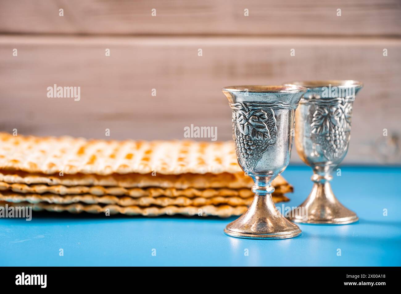 Happy passover. Metal goblet and traditional matzah on blue background ...