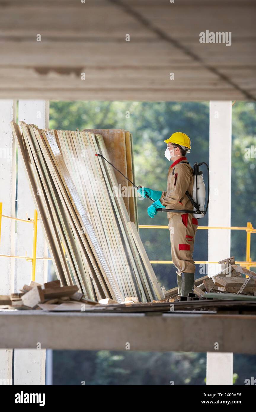 Applying form release agents with sprayer, concrete formworks, housing ...