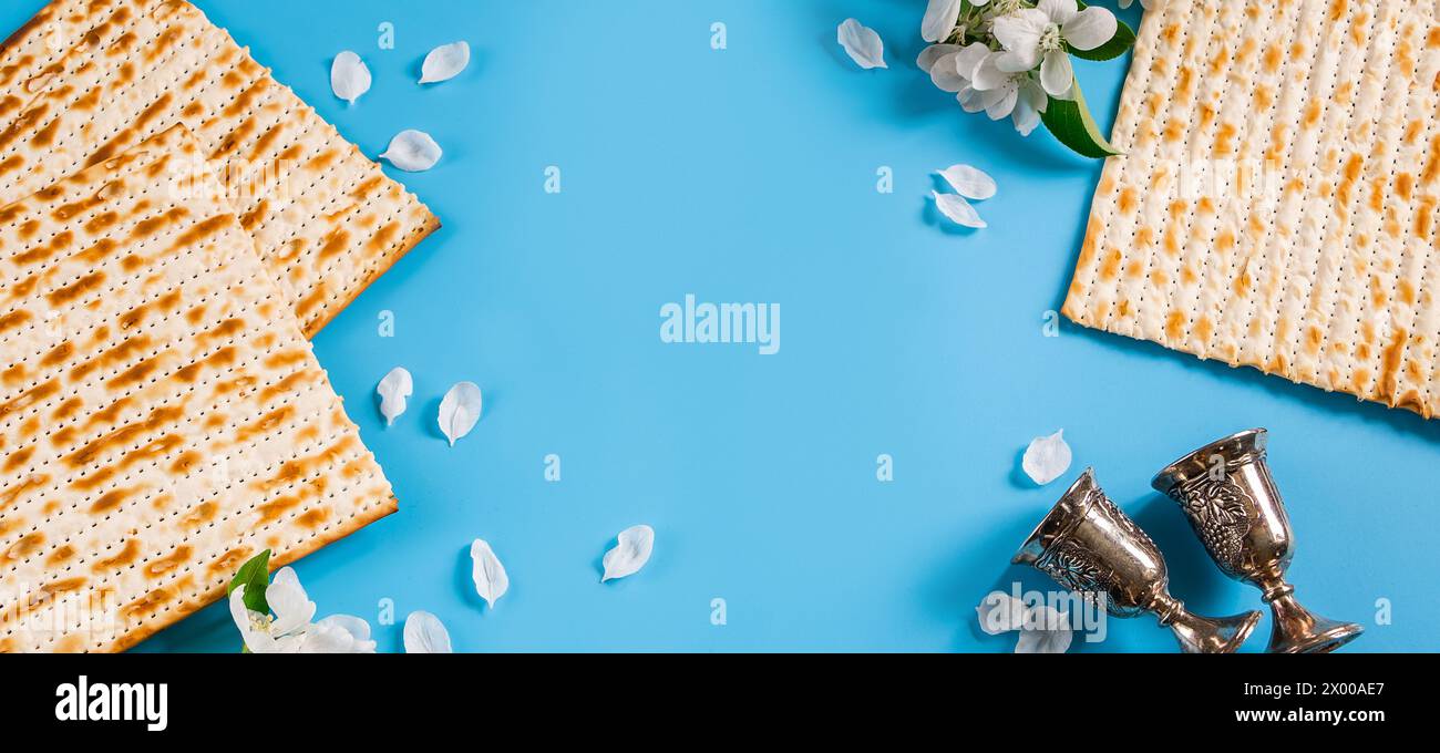 Happy passover flatlay. Metal goblet, spring flowers and traditional ...