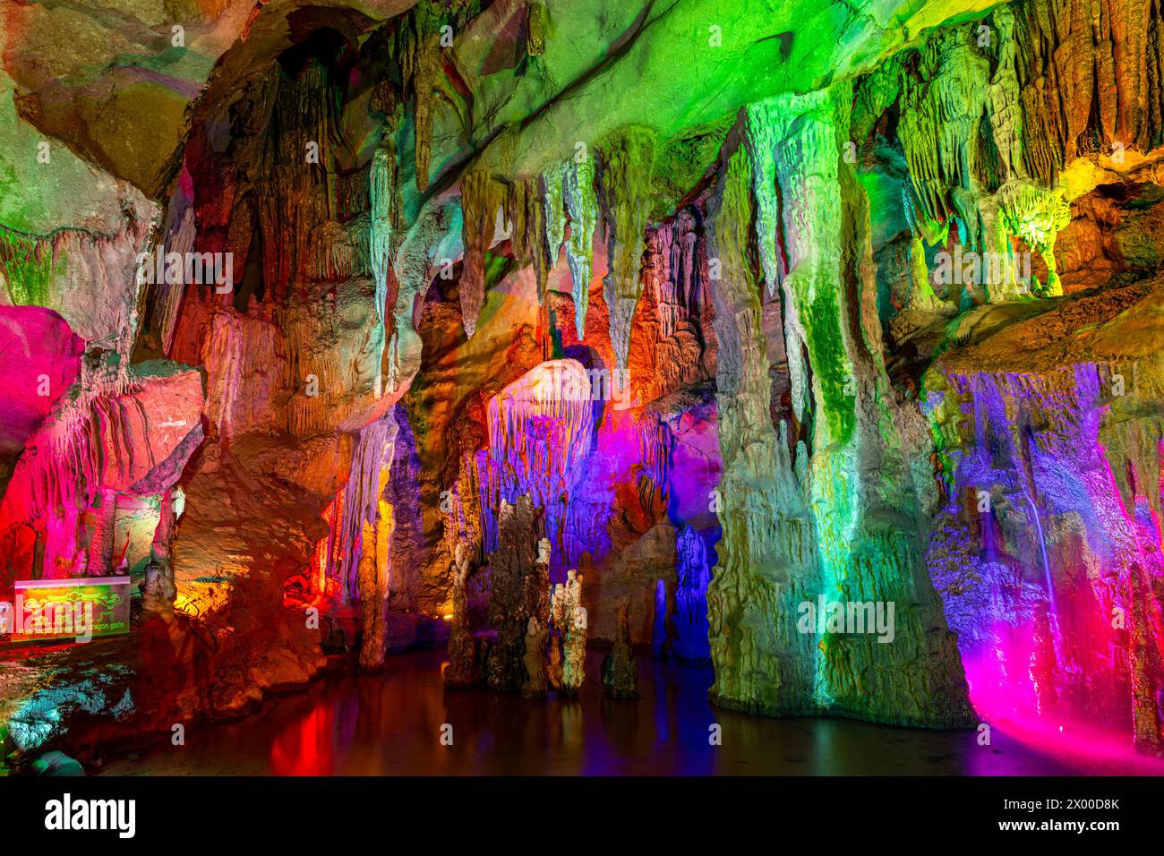 Inside the cave. Stalactites, stalagmites, colored light. Beautiful ...