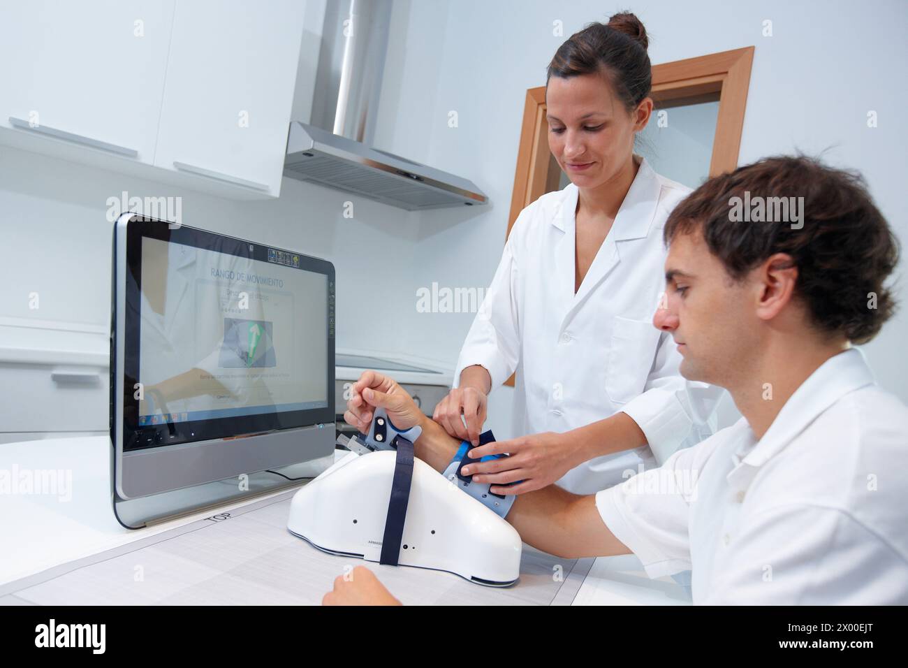 Investigator and patient with assistive robot for upper limb ...