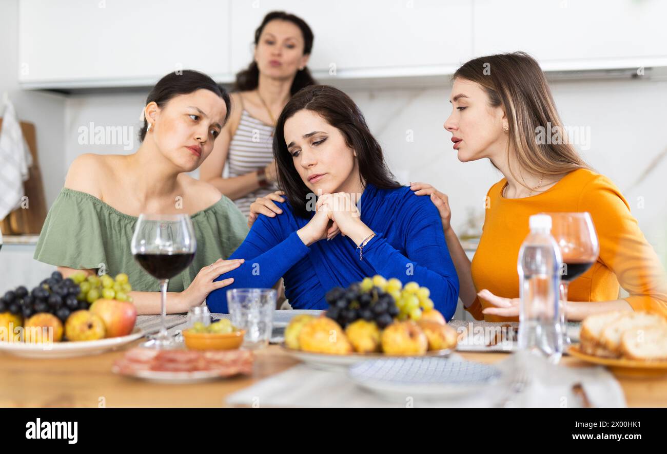 Group of female friends calming woman Stock Photo - Alamy