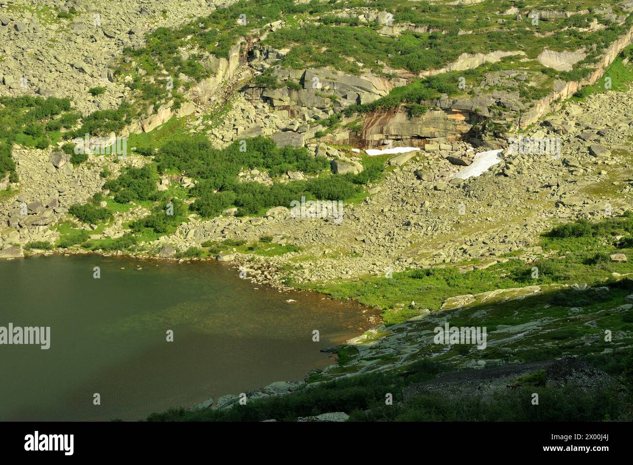 Top view of a fragment of a large lake surrounded by gentle slopes of ...