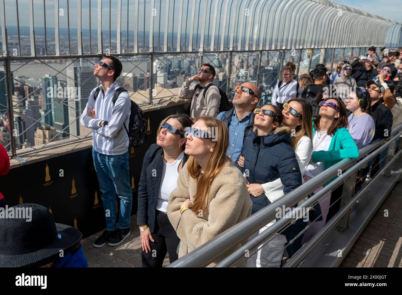 NEW YORK, NEW YORK - APRIL 08: People watch a partial solar eclipse ...