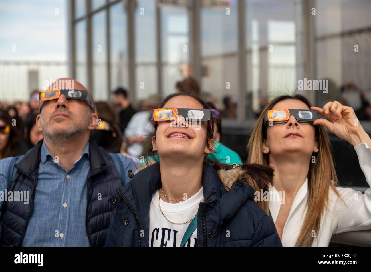 NEW YORK, NEW YORK - APRIL 08: People watch a partial solar eclipse ...