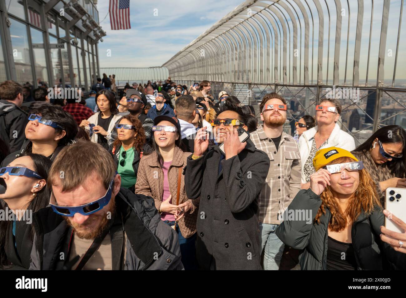 NEW YORK, NEW YORK - APRIL 08: People watch a partial solar eclipse ...