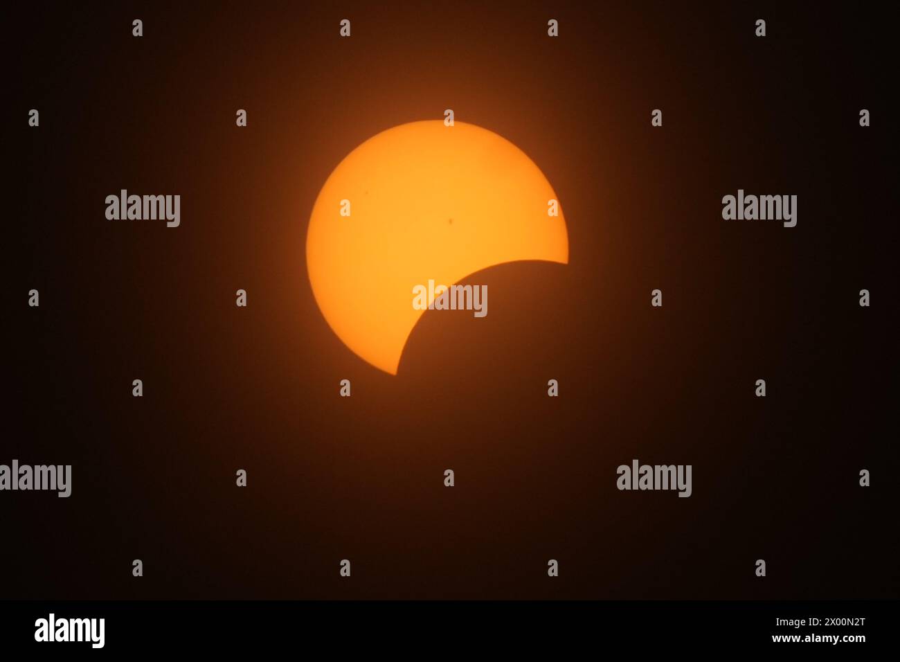 The moon passes in front of the sun during a solar eclipse seen from ...