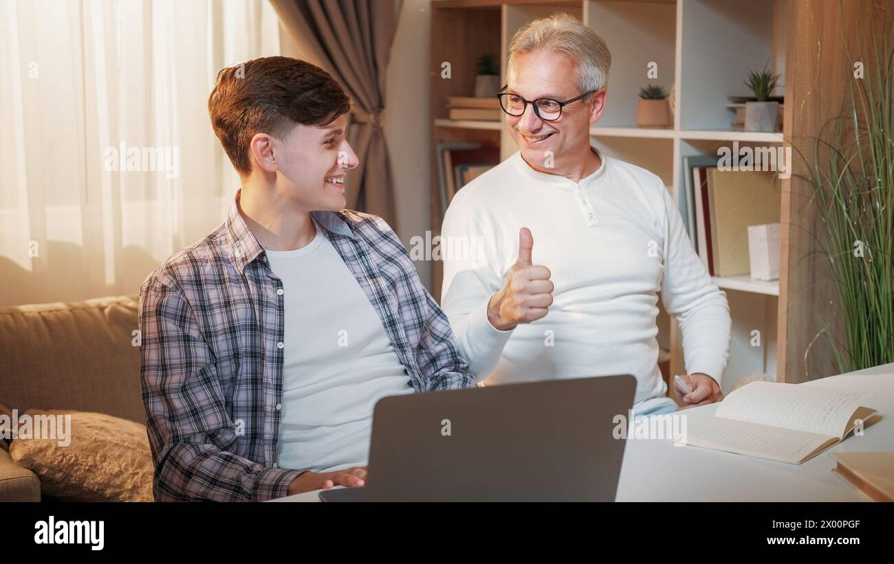 Son showing homework on laptop hi-res stock photography and images - Alamy