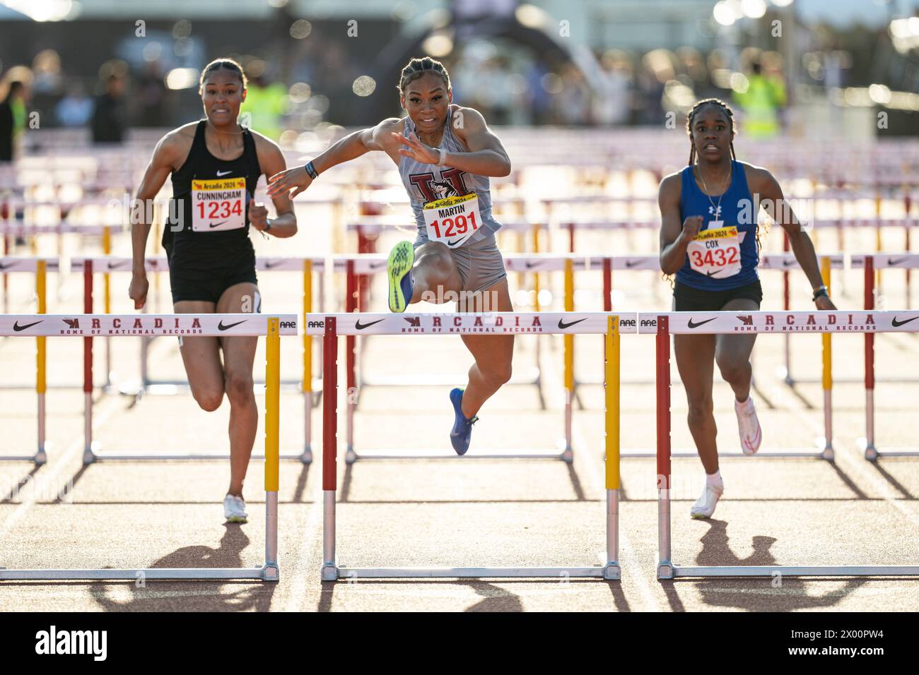 Kiori Martin of Hamilton (center) wins the invitational 100 meter ...