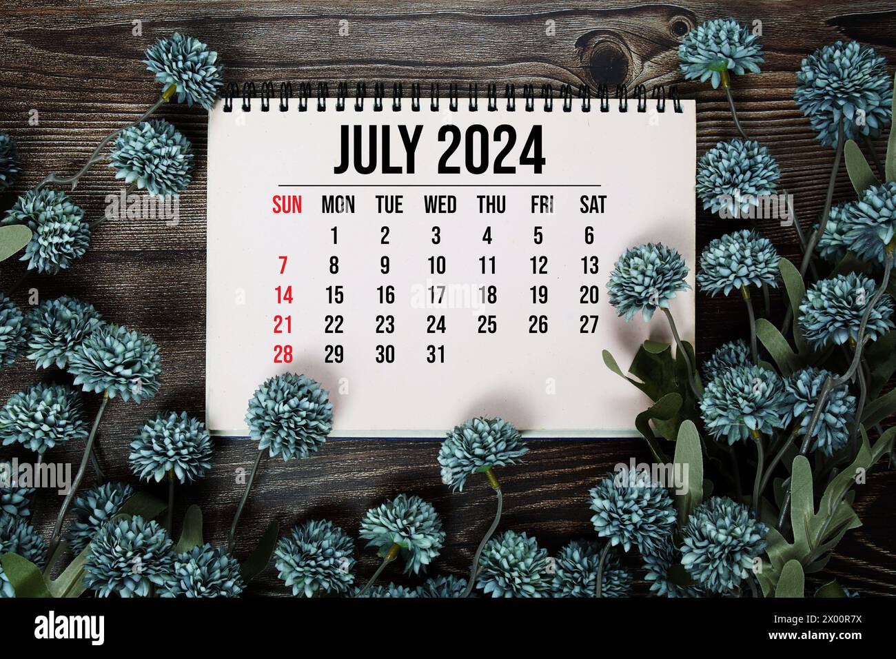 July 2024 monthly calendar with flower bouquet decoration on wooden ...
