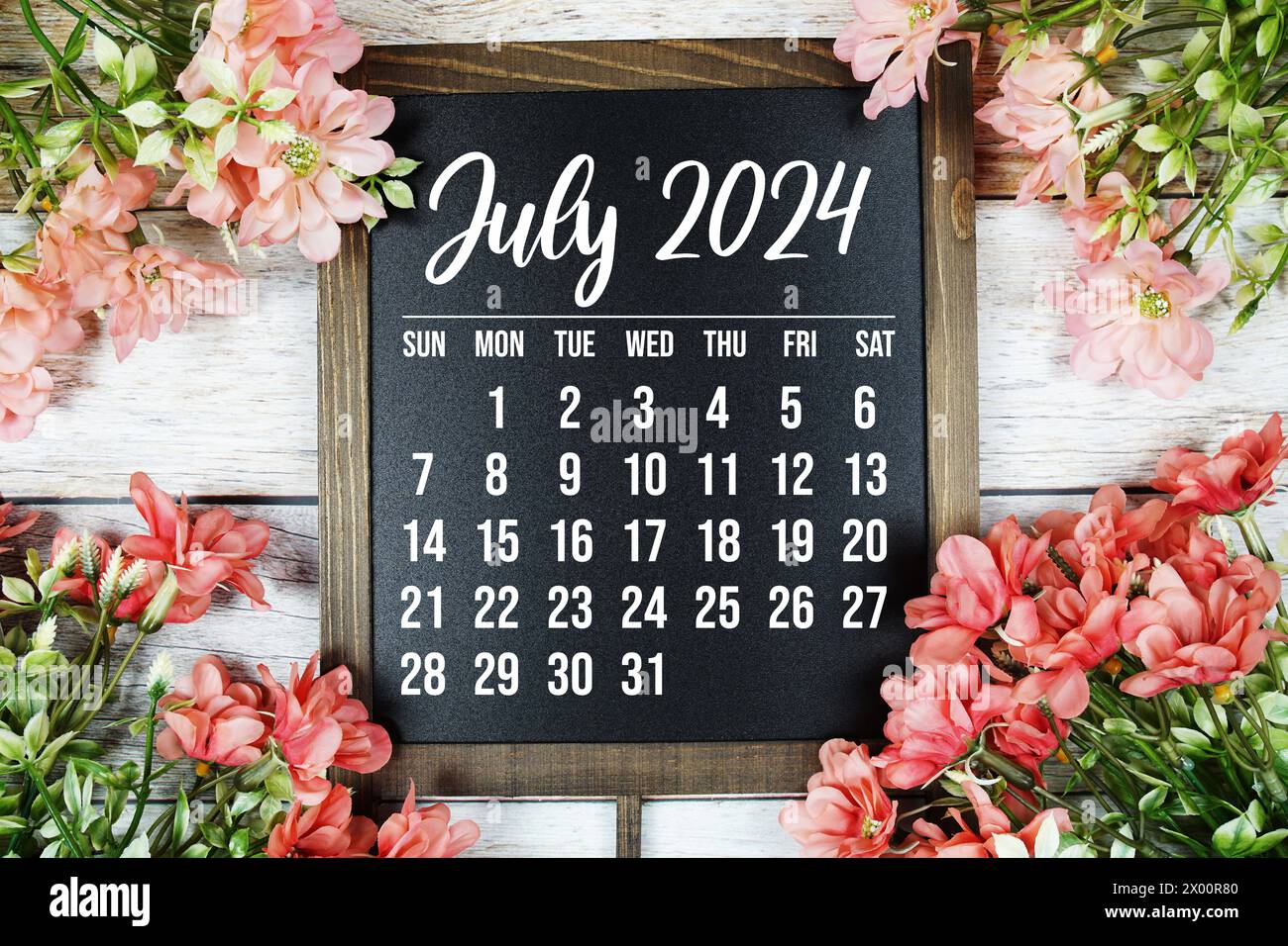 July 2024 monthly calendar with flower bouquet decoration on wooden ...