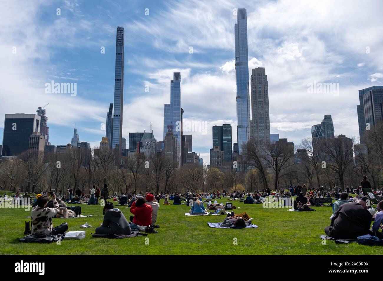 People enjoying the eclipse with a city skyscraper view facing south ...