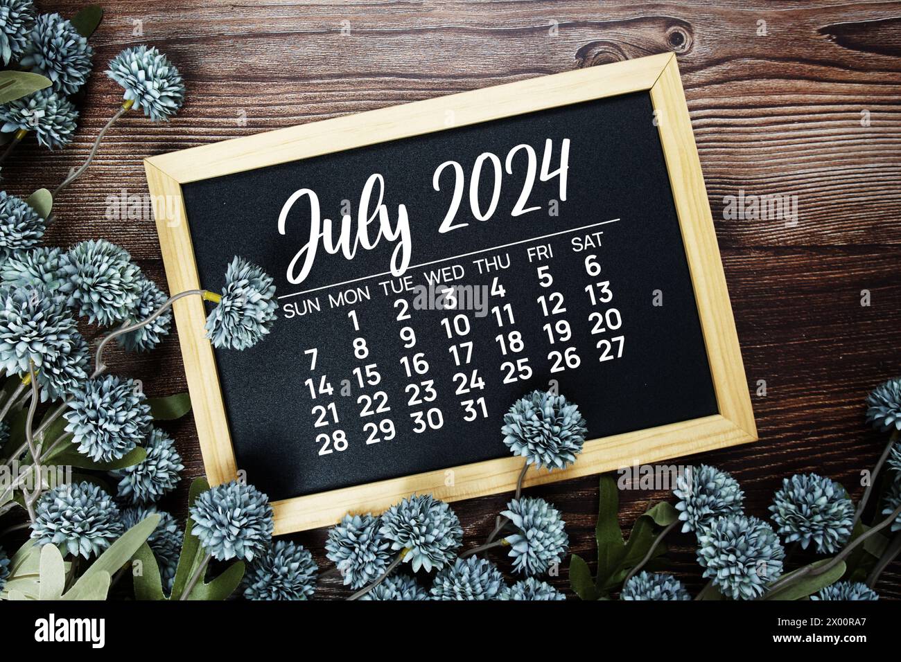 July 2024 monthly calendar with flower bouquet decoration on wooden ...