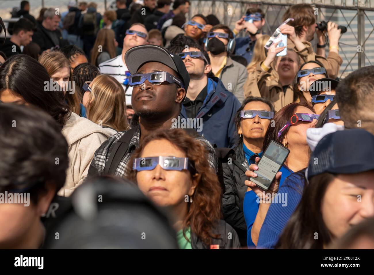 New York, United States. 08th Apr, 2024. People watch a partial solar ...