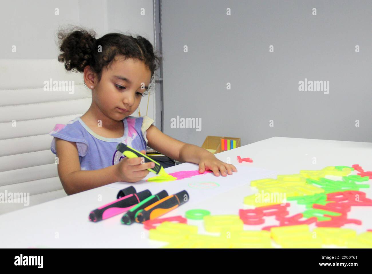 3 year old Latina brunette girl with curly hair draws as therapy for ...