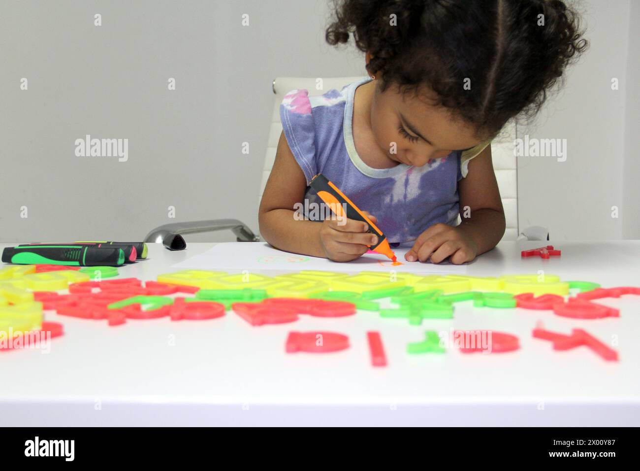 3 year old Latina brunette girl with curly hair draws as therapy for ...