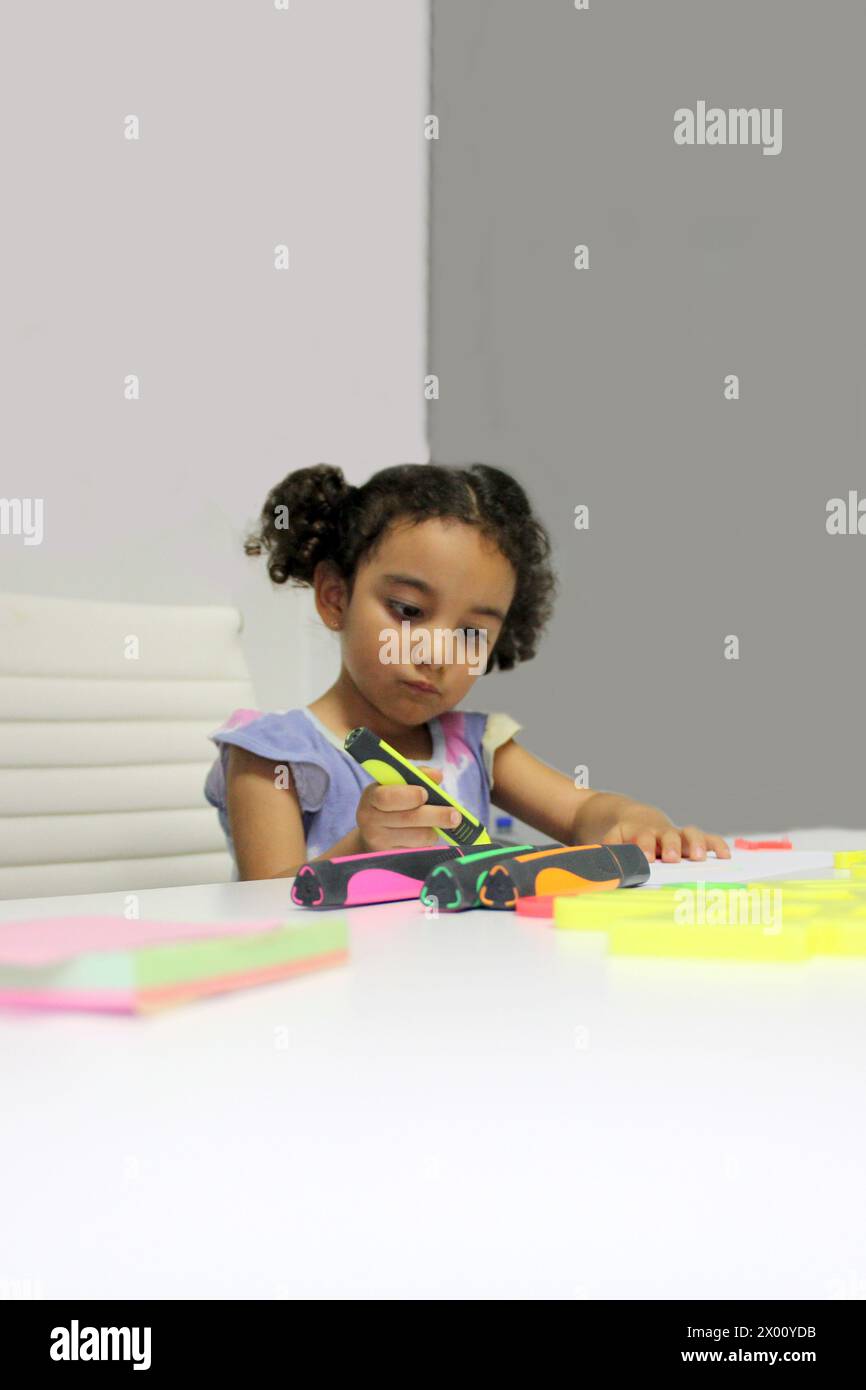 3 year old Latina brunette girl with curly hair draws as therapy for ...